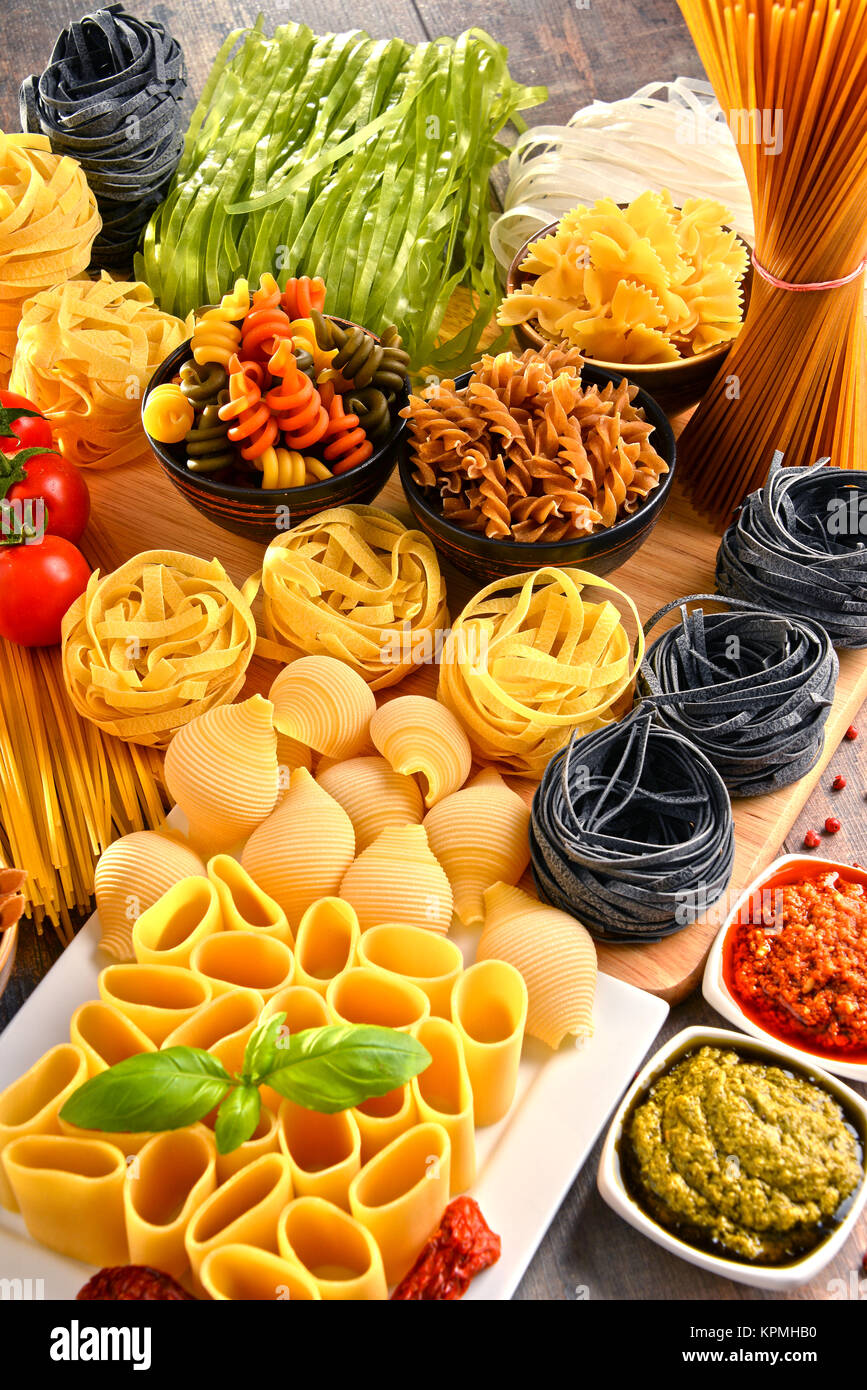 Composition with variety of pasta on kitchen table Stock Photo - Alamy