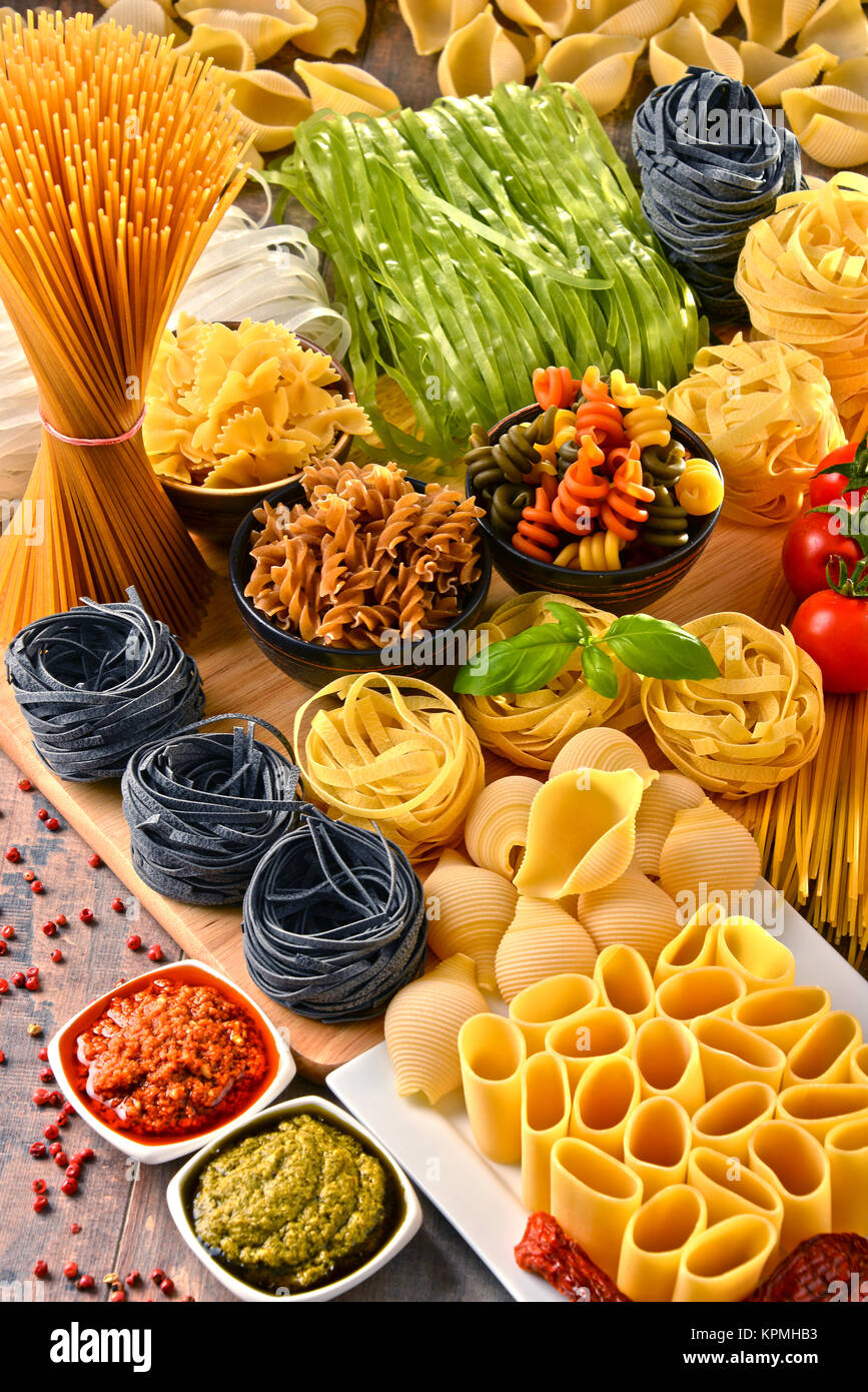 Composition with variety of pasta on kitchen table Stock Photo - Alamy