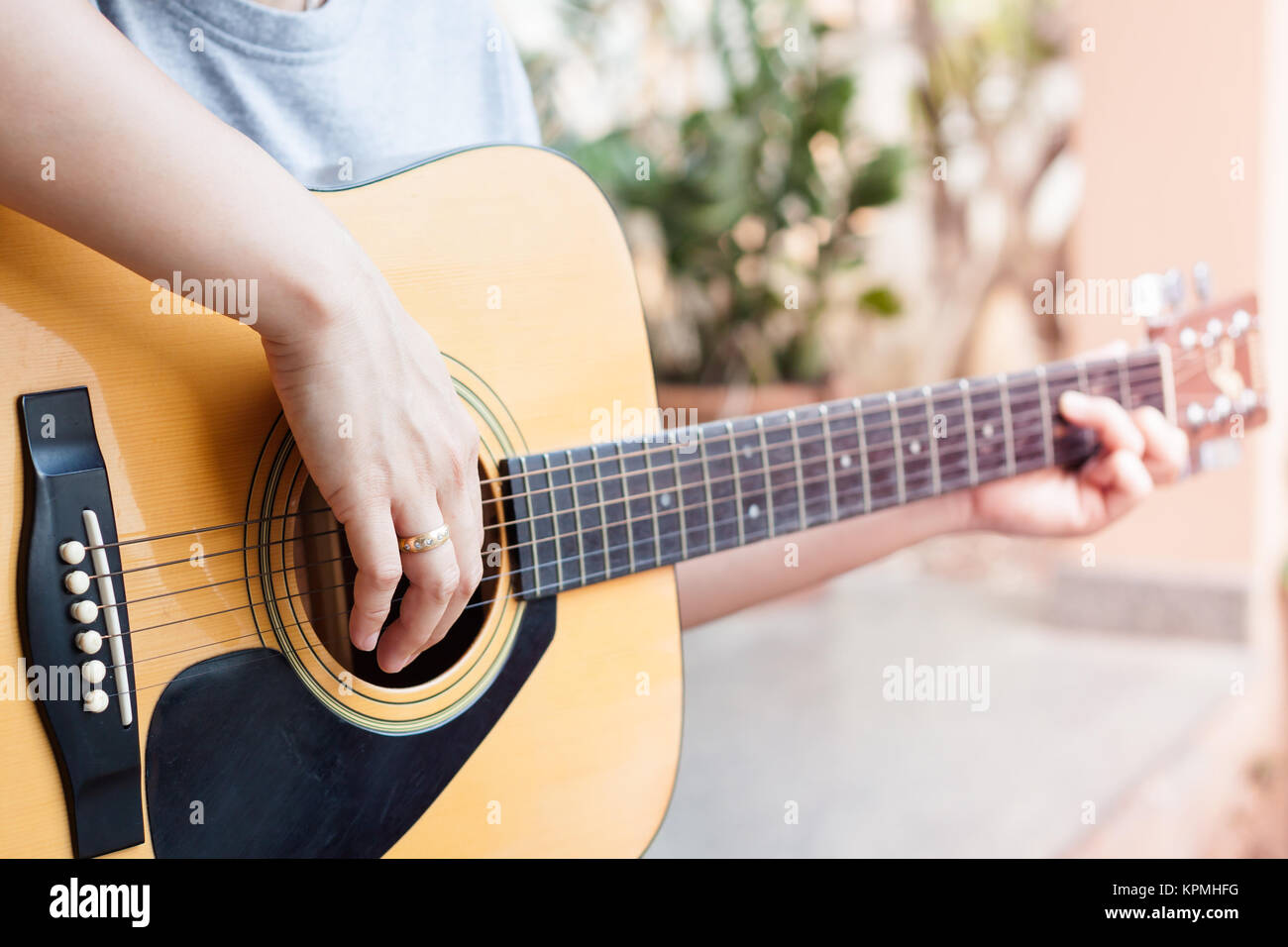 Woman's hands playing acoustic guitar Stock Photo - Alamy