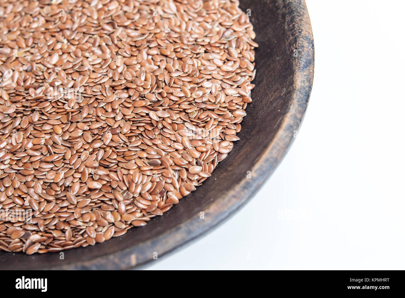 Linseeds flax in rustic wooden bowl isolated white background Stock Photo - Alamy
