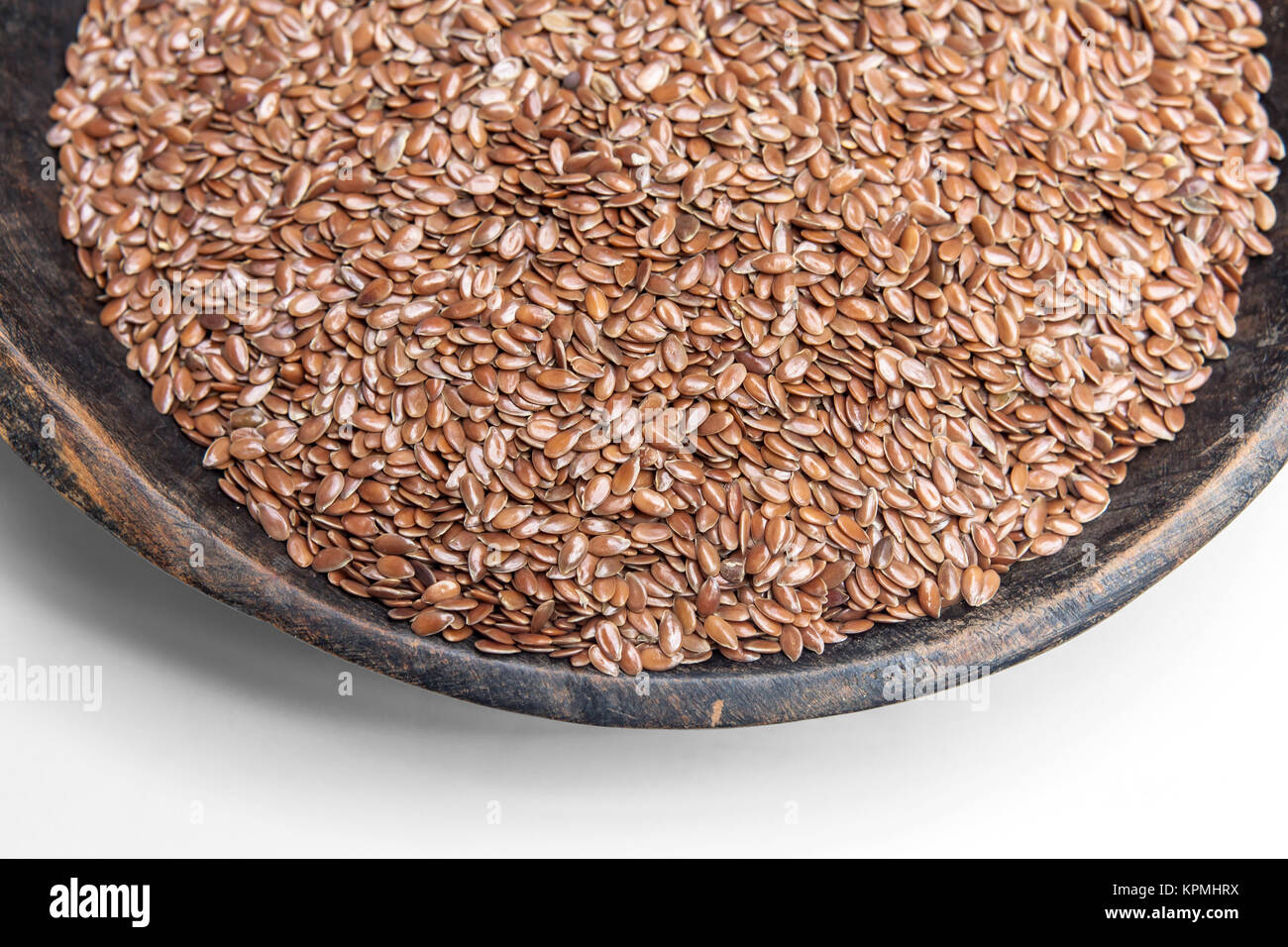 Linseeds flax in rustic wooden bowl isolated white background Stock Photo - Alamy
