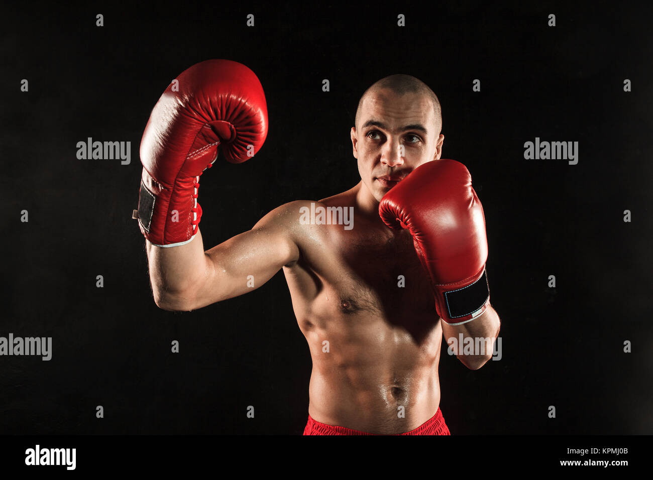 The young man kickboxing on black Stock Photo - Alamy