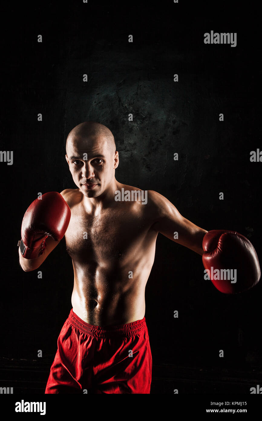 The young man kickboxing on black Stock Photo - Alamy