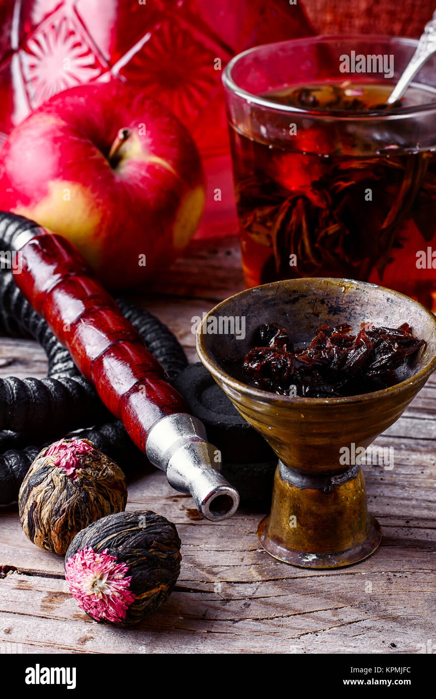 Cup of brewed herbal tea from rose and Turkish hookah Stock Photo - Alamy