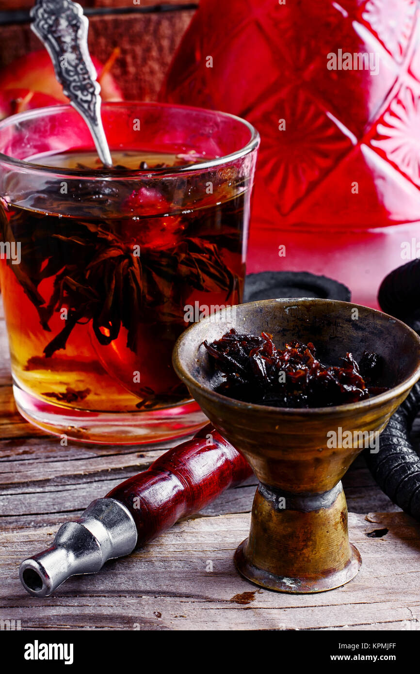 Cup of brewed herbal tea from rose and Turkish hookah Stock Photo - Alamy