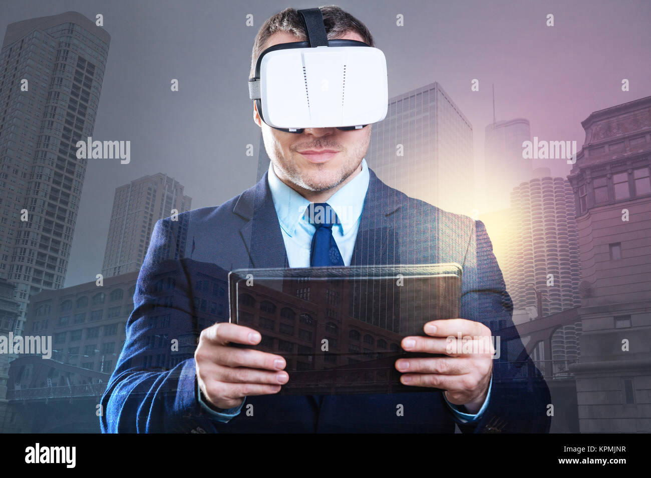 Successful young man working with VR headset and tablet computer Stock ...