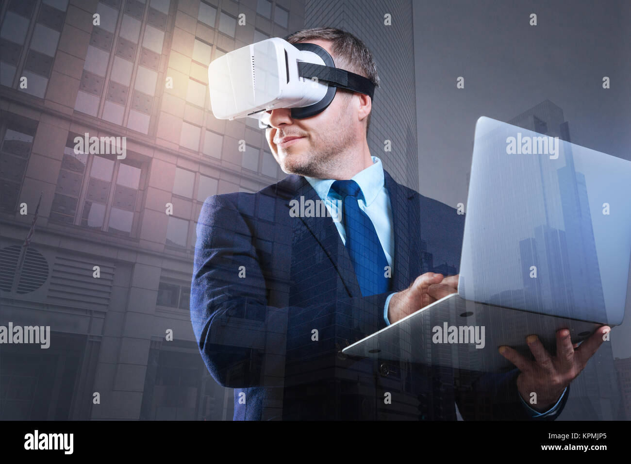 Smiling entrepreneur wearing VR headset using laptop Stock Photo - Alamy Smiling entrepreneur wearing VR headset using laptop Stock Photo - Alamy