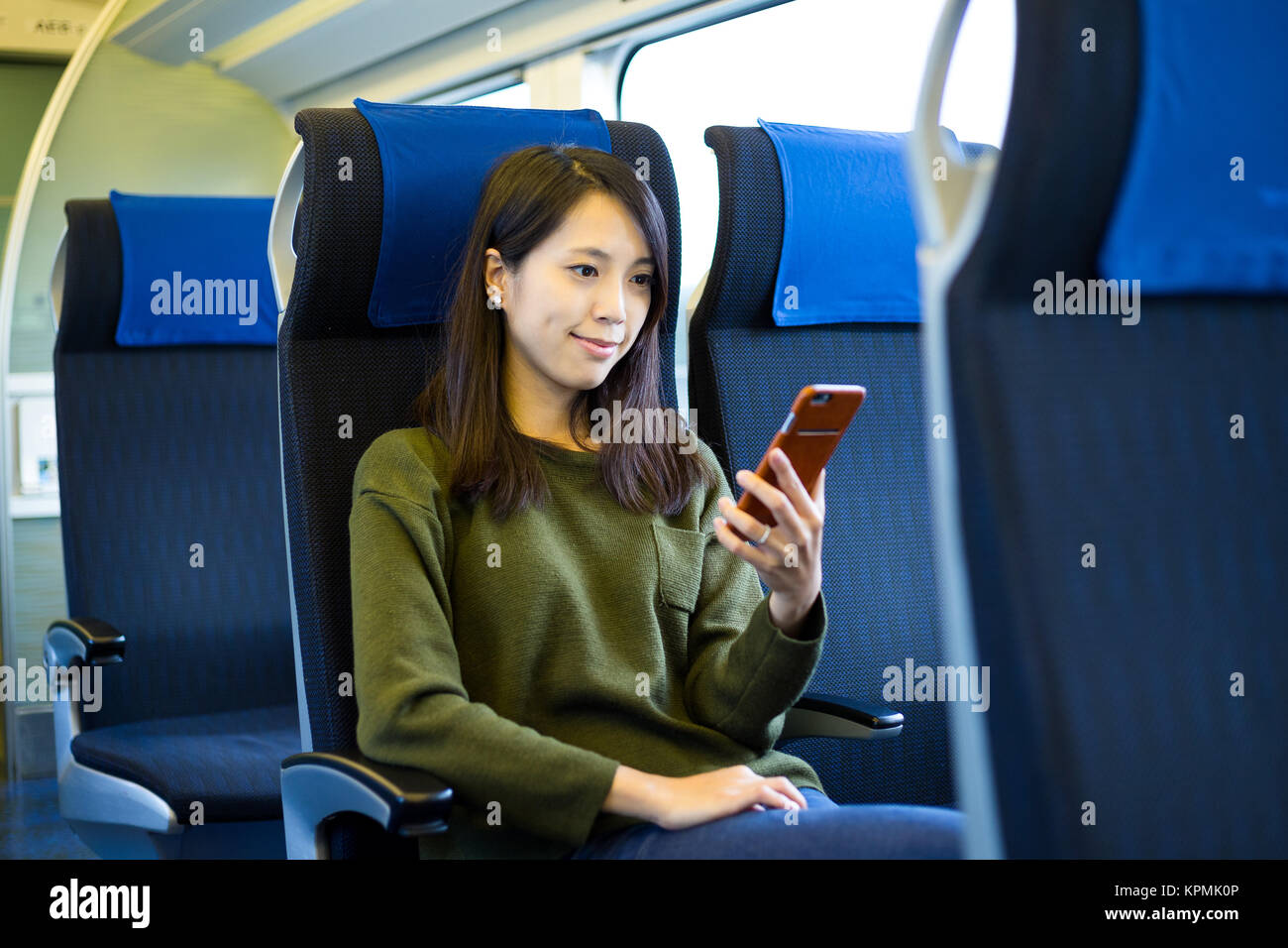 Woman use of cellphone inside train compartment Stock Photo - Alamy
