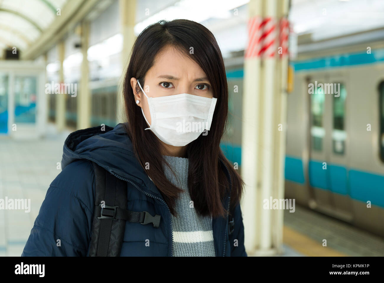 Woman wearing face mask at train station Stock Photo - Alamy