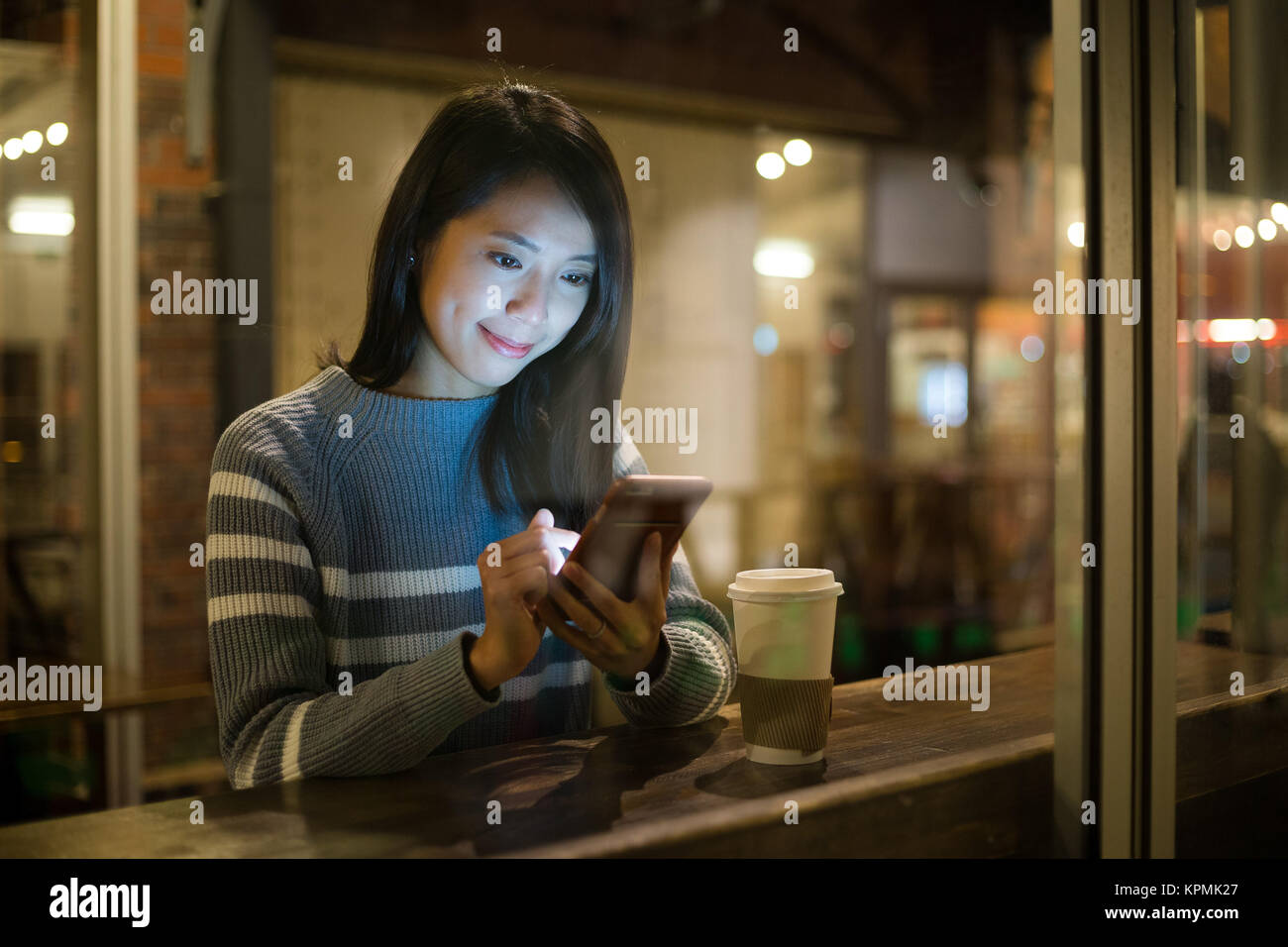 Woman using cellphone at coffee shop Stock Photo - Alamy