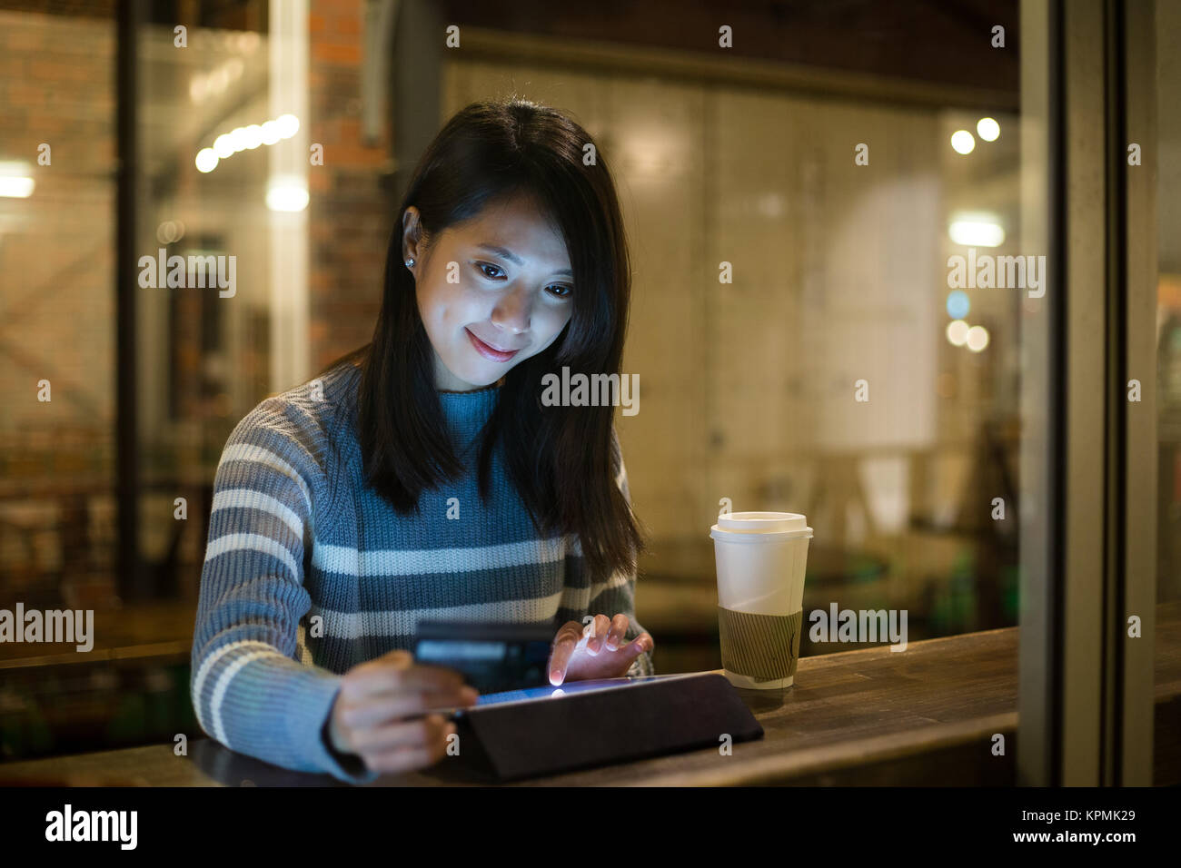 Woman using tablet pc for booking hotel for next trip Stock Photo - Alamy