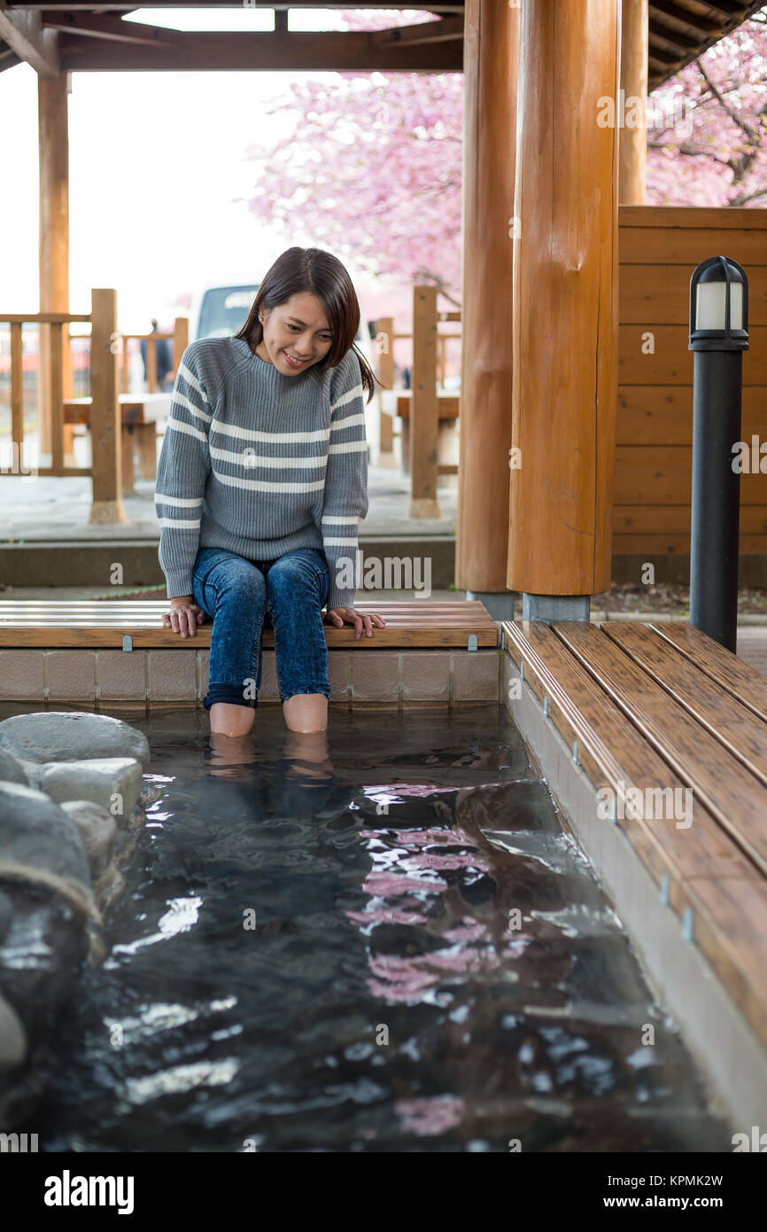 Woman enjoy hot spring on her foot Stock Photo - Alamy