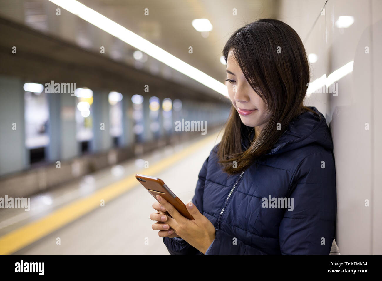 Woman using cell phone in the subway hi-res stock photography and ...