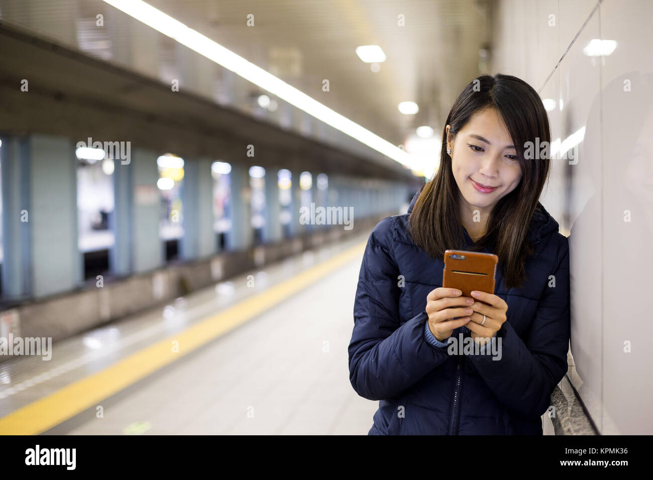 Young woman use of mobile phone in tokyo city metro Stock Photo - Alamy