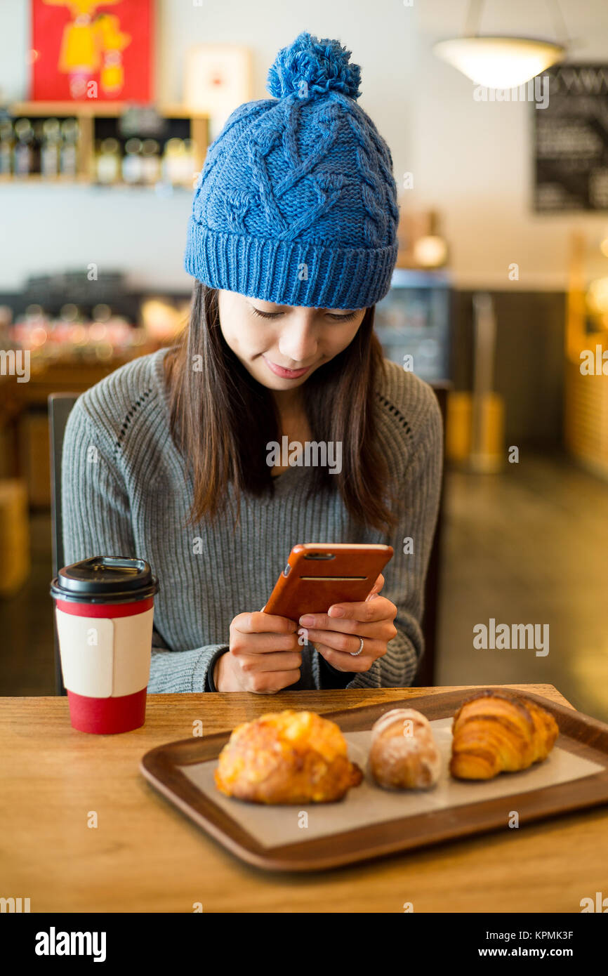 Young Woman use of smart phone in coffee shop at morning Stock Photo ...