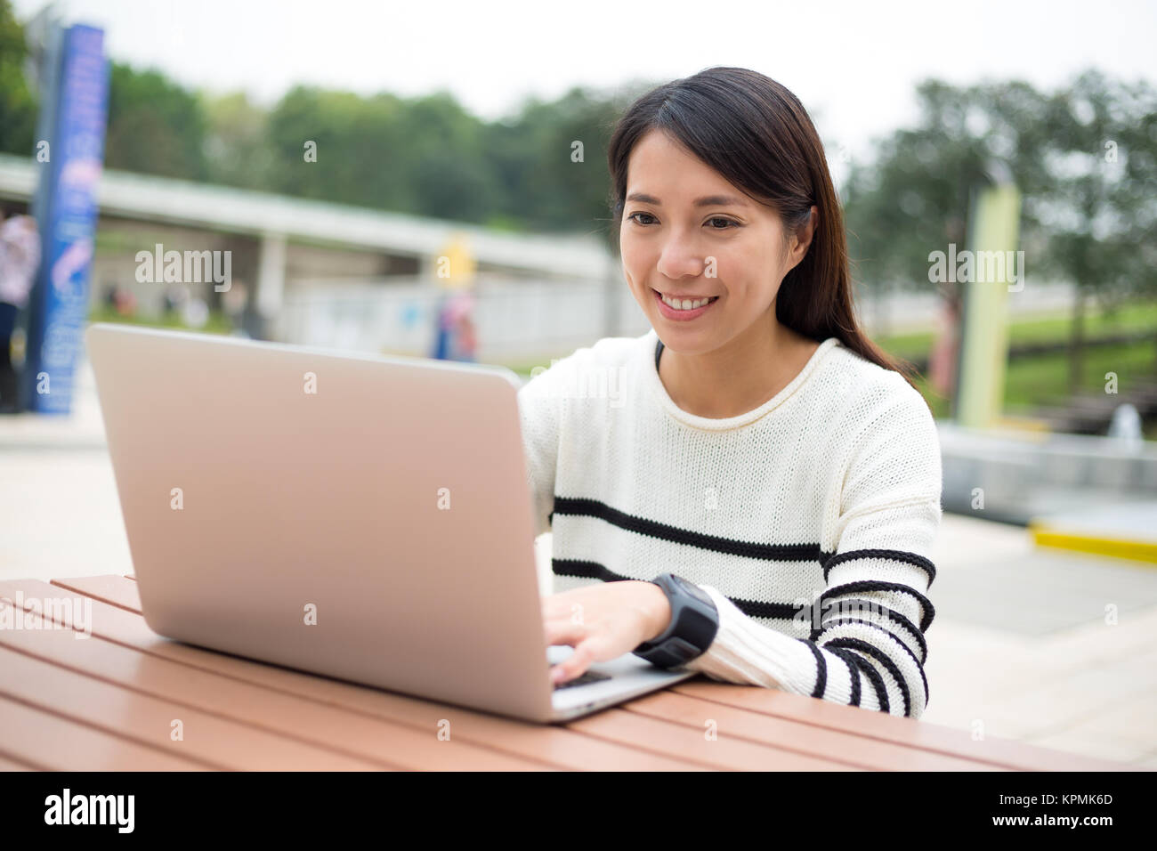 Woman typing on laptop computer with smart watch Stock Photo - Alamy