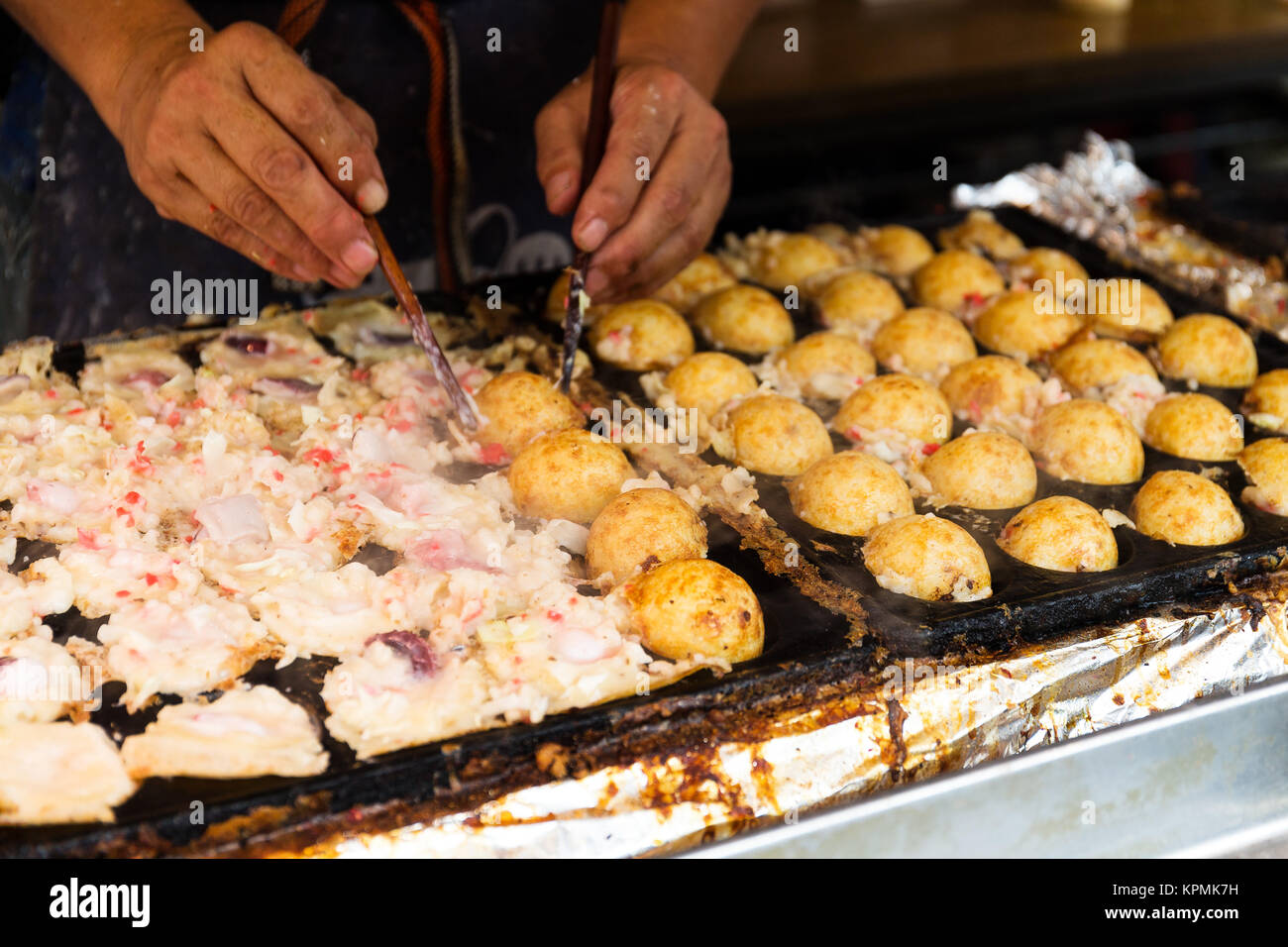Making of tako yaki at stall Stock Photo - Alamy