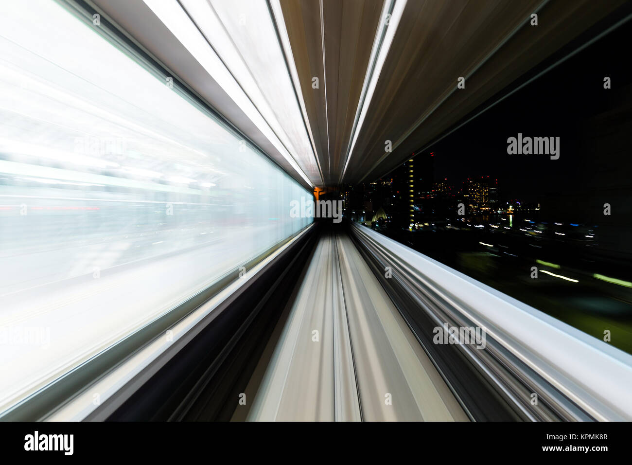 Fast train passing through city Stock Photo - Alamy