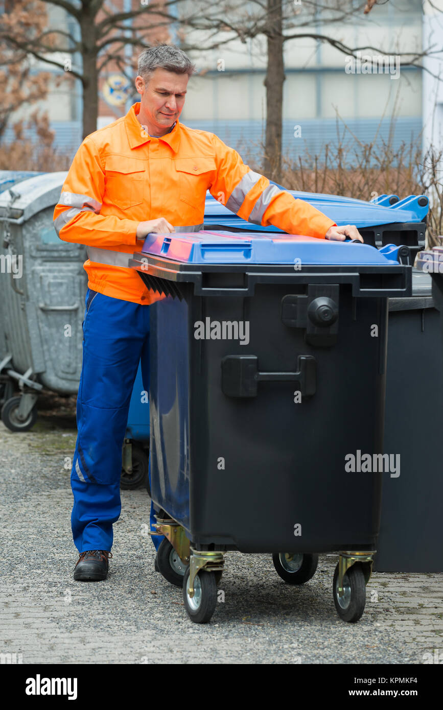 Working Man Standing Near Dustbin On Street Stock Photo - Alamy