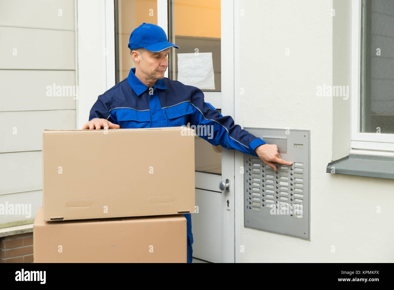 Delivery man using intercom hi-res stock photography and images - Alamy