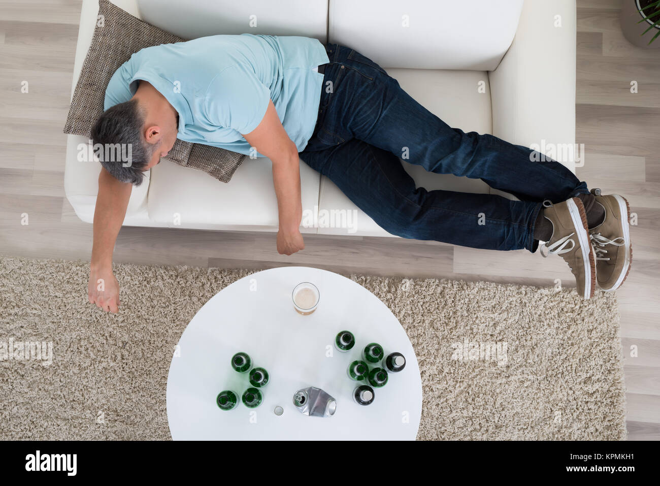 Man Taking A Nap On Sofa At Home Stock Photo - Alamy