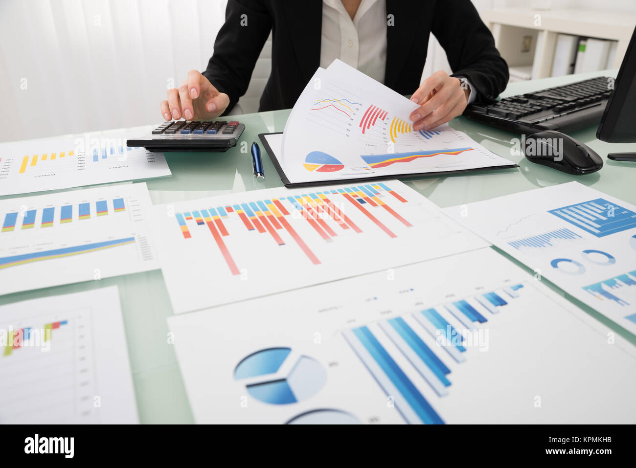Businesswoman Analyzing Report On Chart Stock Photo - Alamy