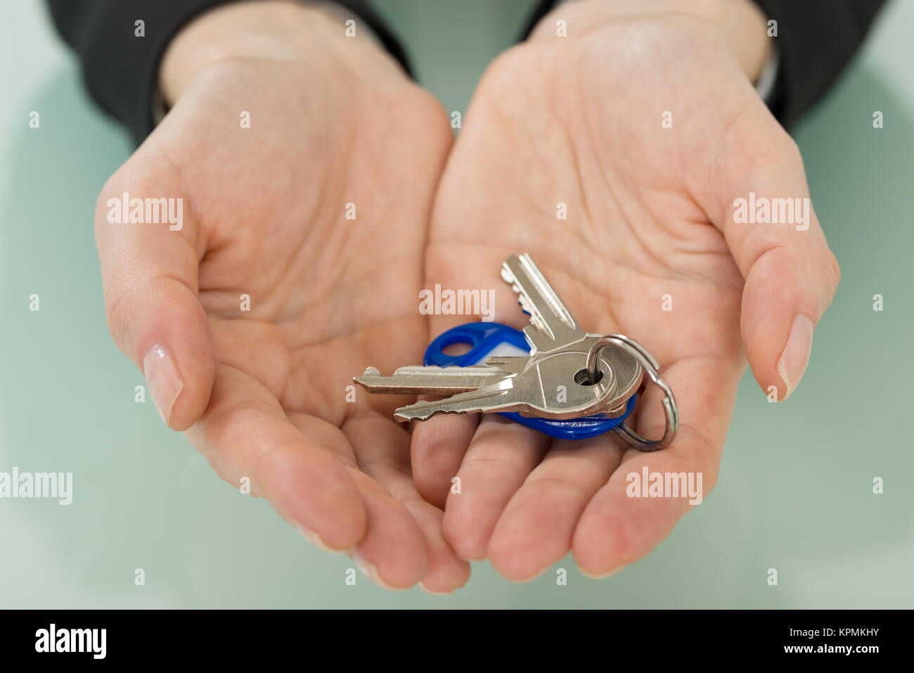 Businesswoman Hand Holding Key Stock Photo - Alamy