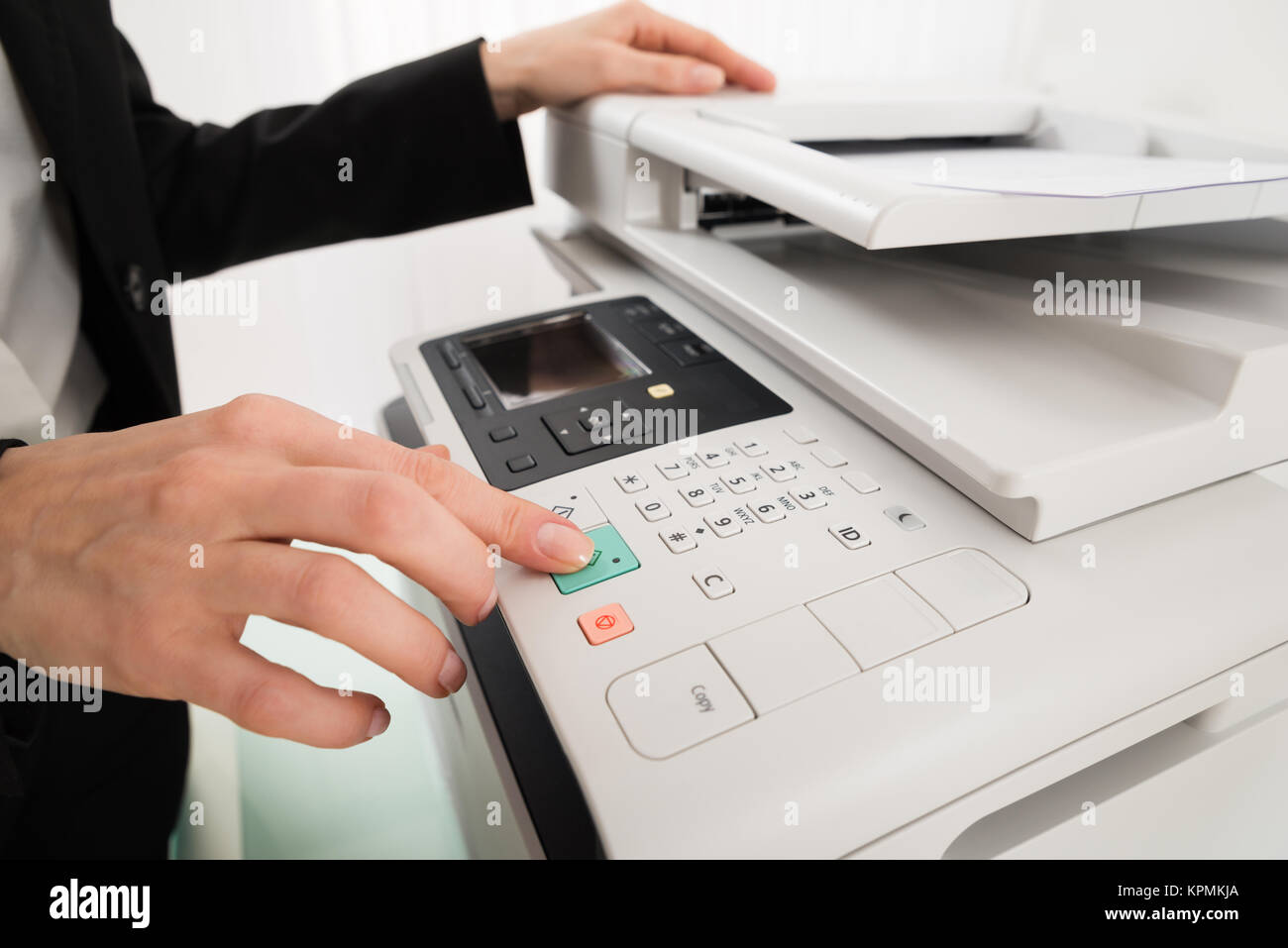 Businesswoman Hand Pressing Printer's Button Stock Photo - Alamy