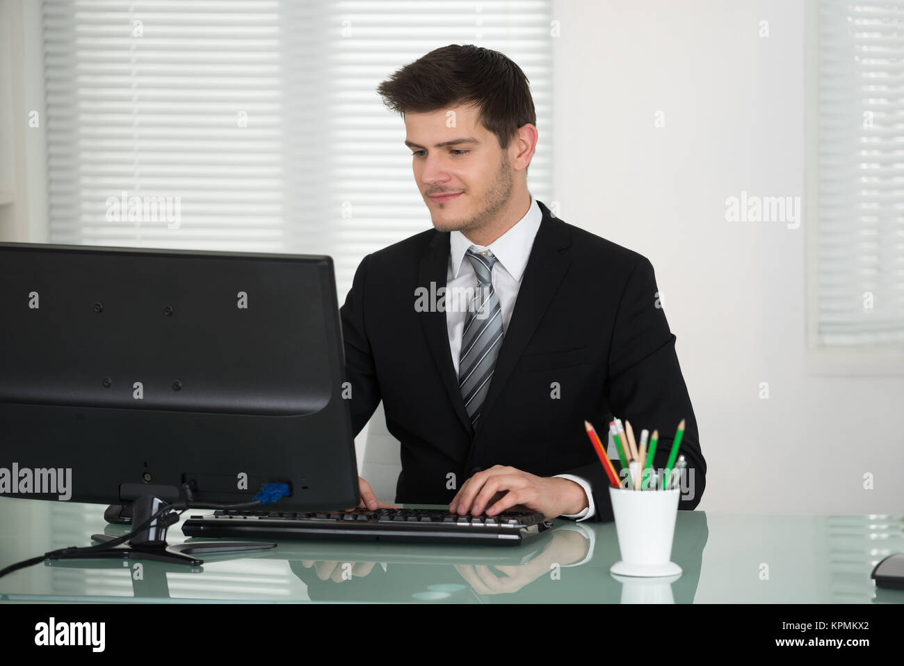 Businessman Working In Office Stock Photo - Alamy