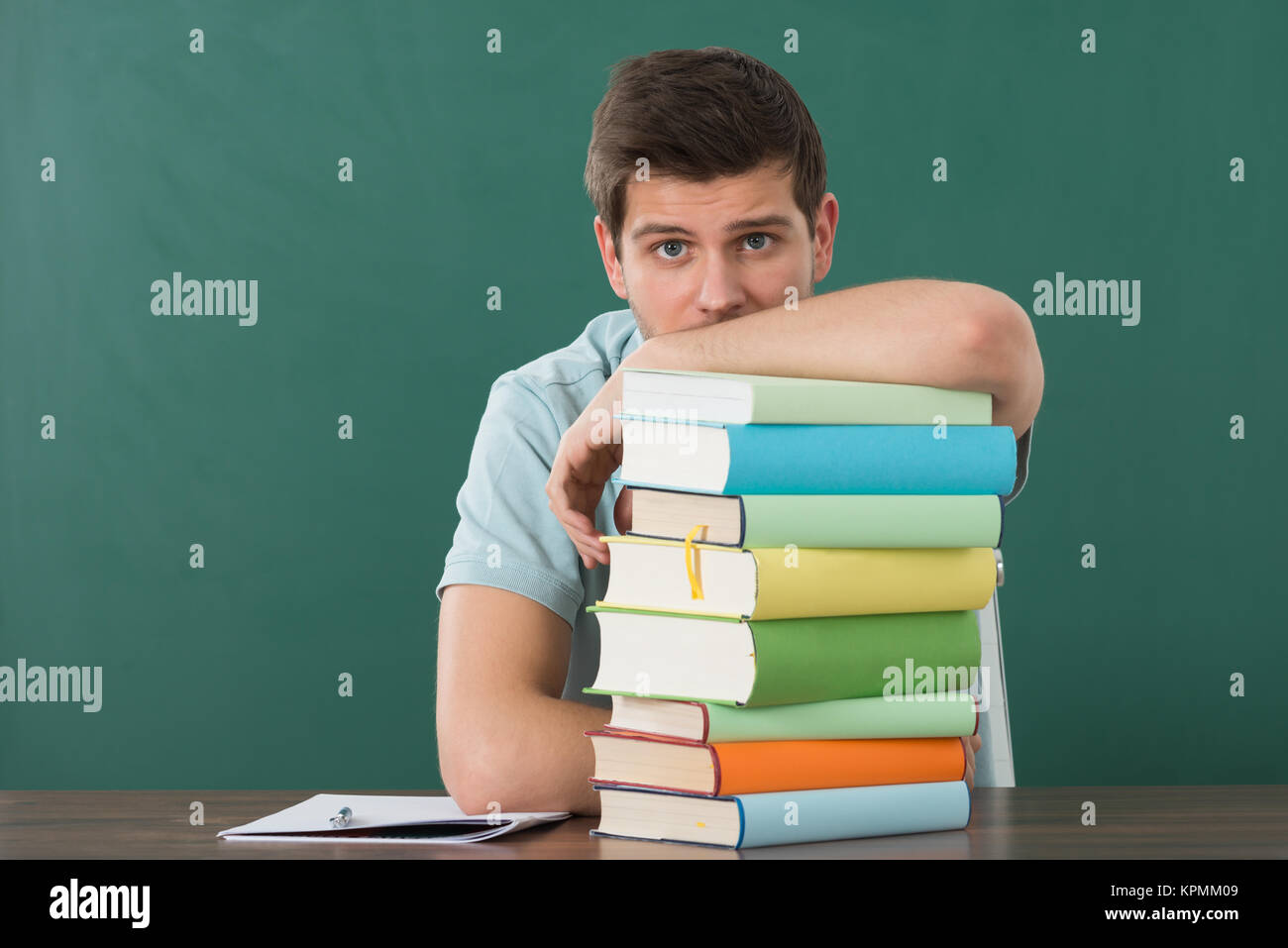 Man Leaning On Stack Of Books Stock Photo - Alamy