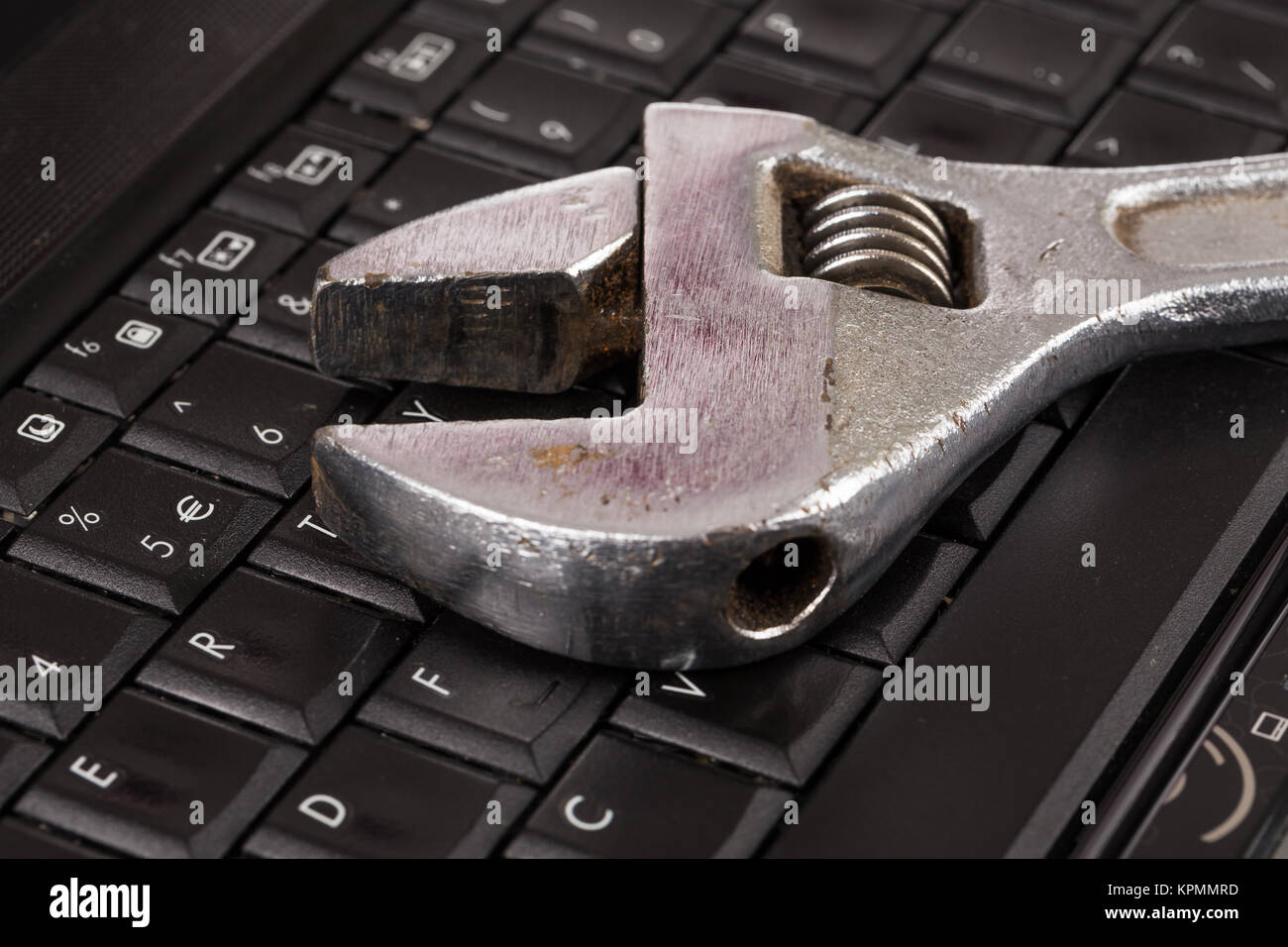 wrench tool over a laptop Stock Photo - Alamy