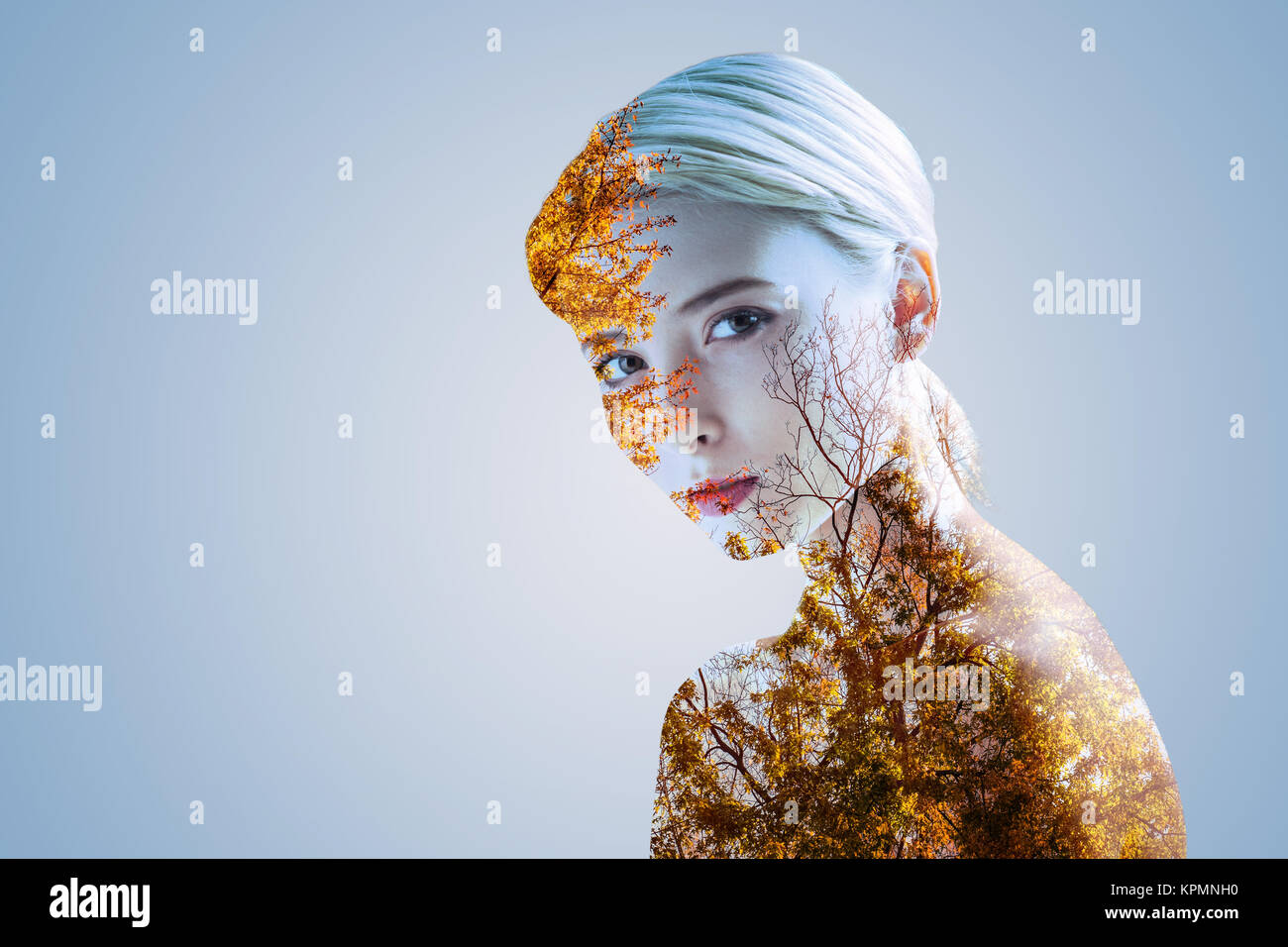 Serious blonde girl looking into camera Stock Photo - Alamy