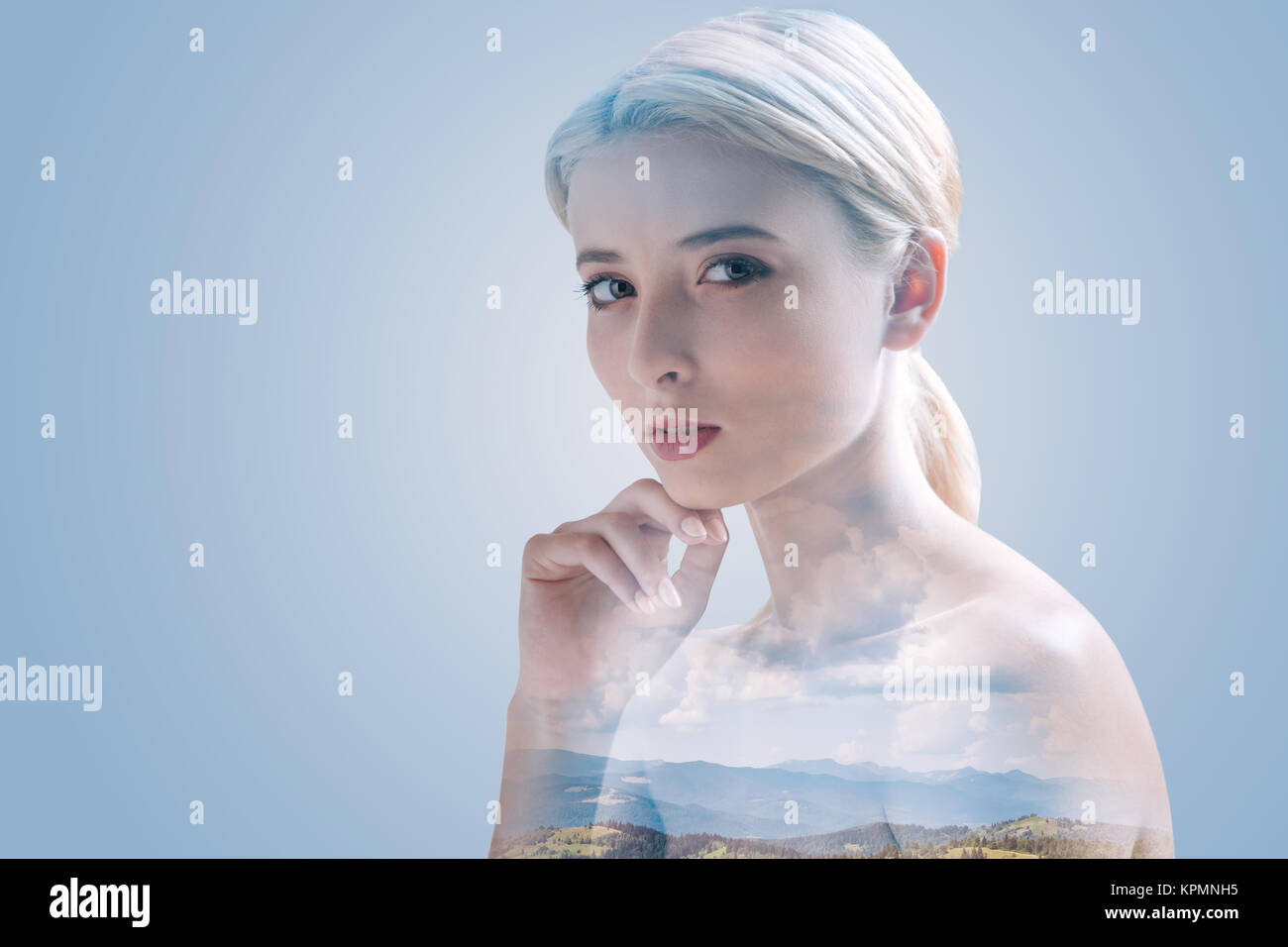 Serious young woman posing against natural background Stock Photo - Alamy