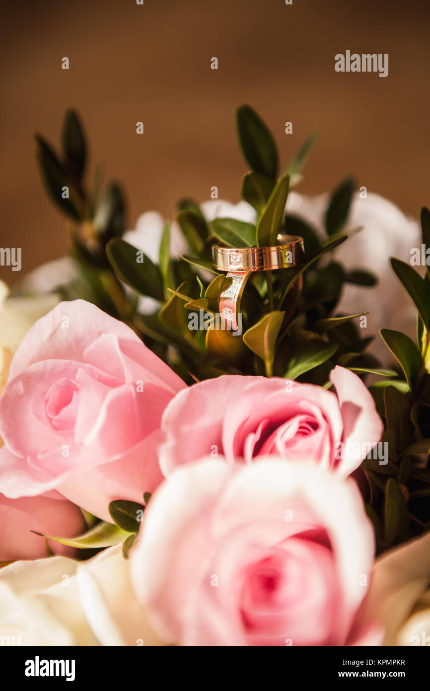 The wedding rings with pink roses Stock Photo - Alamy