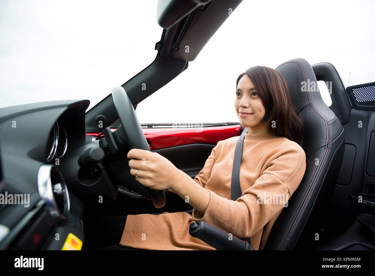 Woman driving convertible car Stock Photo - Alamy