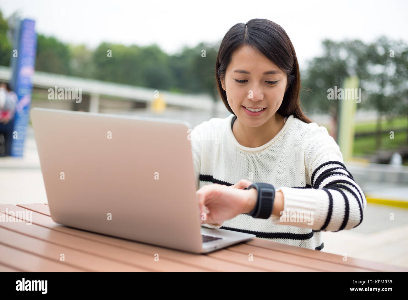 Woman connect with smart watch and laptop computer Stock Photo - Alamy