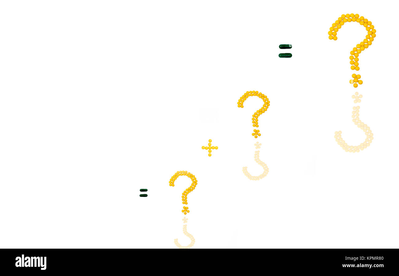 Three question mark and plus sign made of yellow sugar coated tablet ...