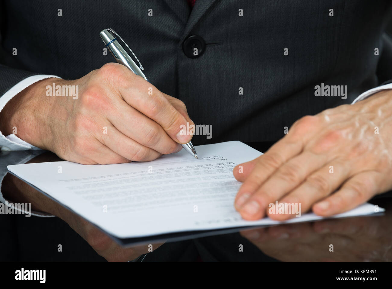 Close-up Of Businessman Hand Holding Pen Over Contract Form Stock Photo ...
