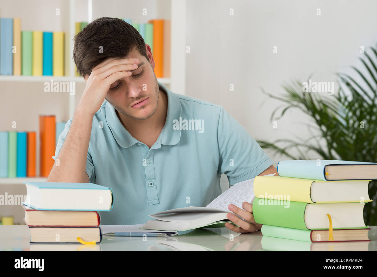 Man Reading Book In Library Stock Photo - Alamy