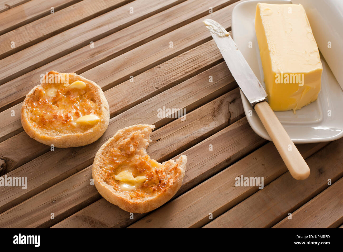 Buttered crumpets for breakfast Stock Photo - Alamy