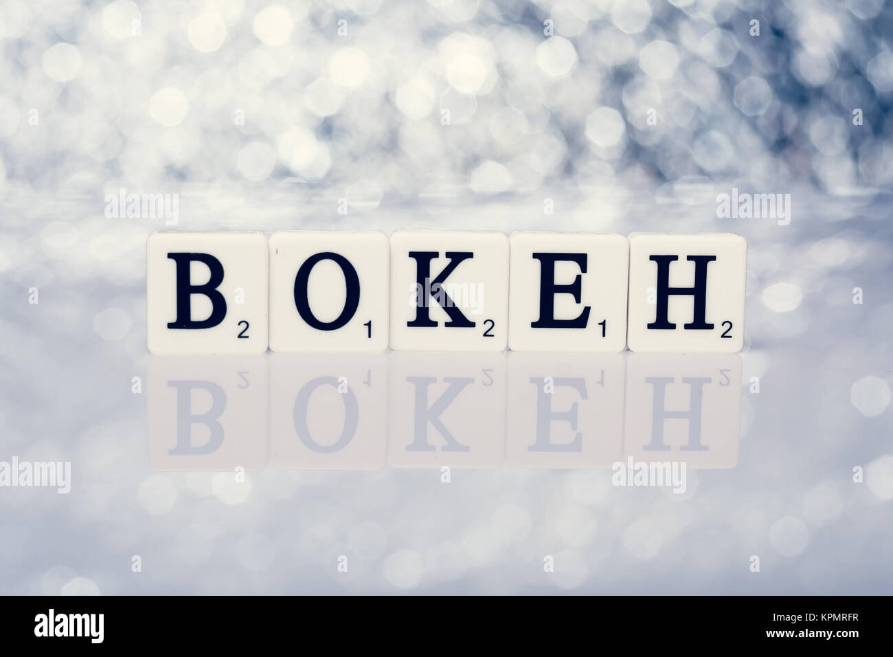 Written word of tiles with letters - bokeh Stock Photo - Alamy