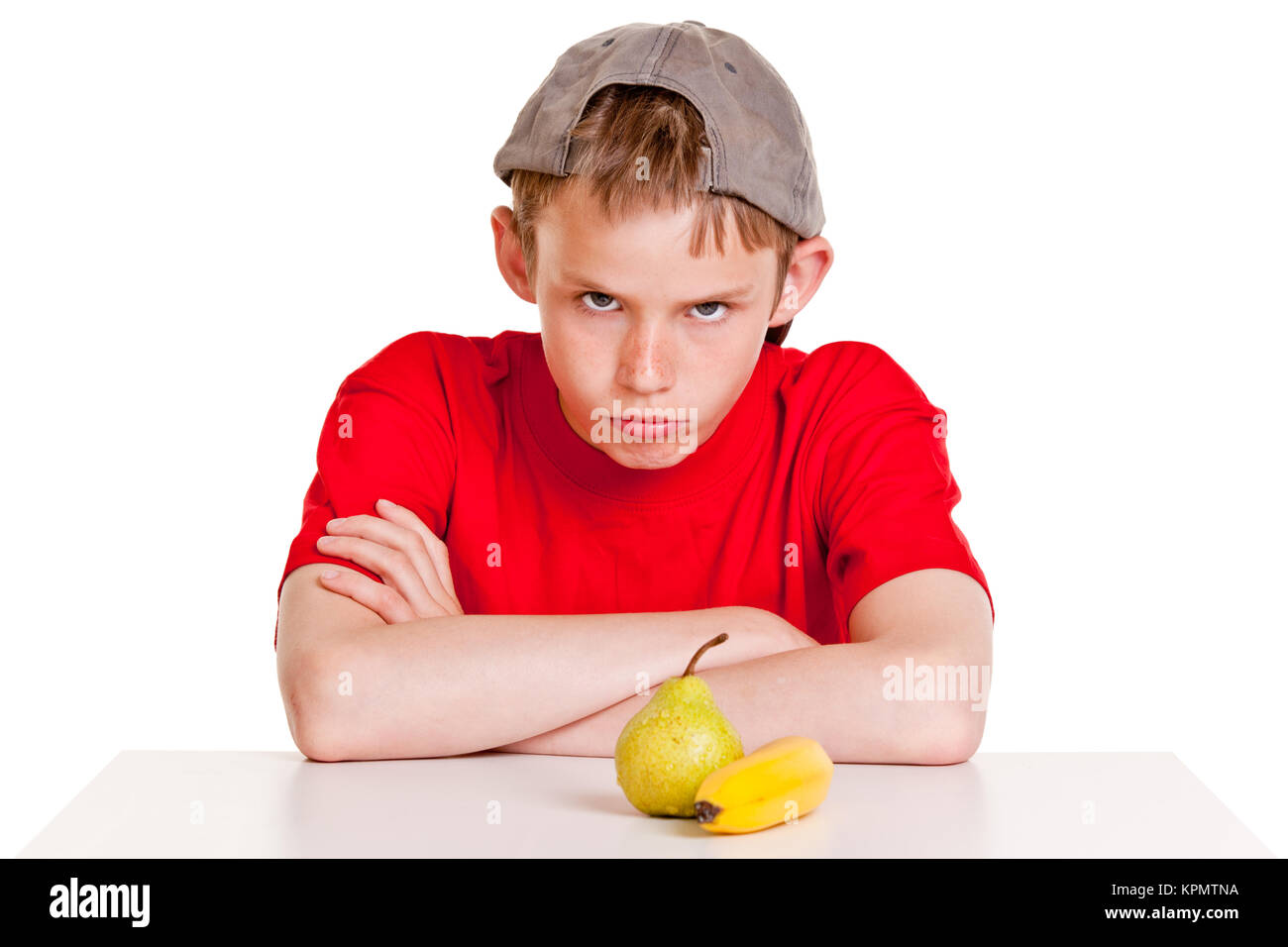 Belligerent young boy with fruit Stock Photo - Alamy