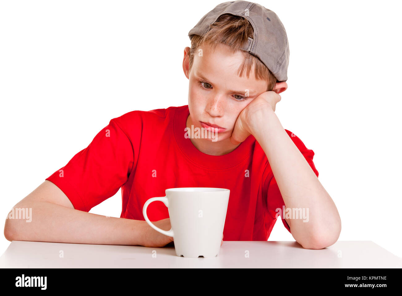 Bored child with white cup Stock Photo - Alamy