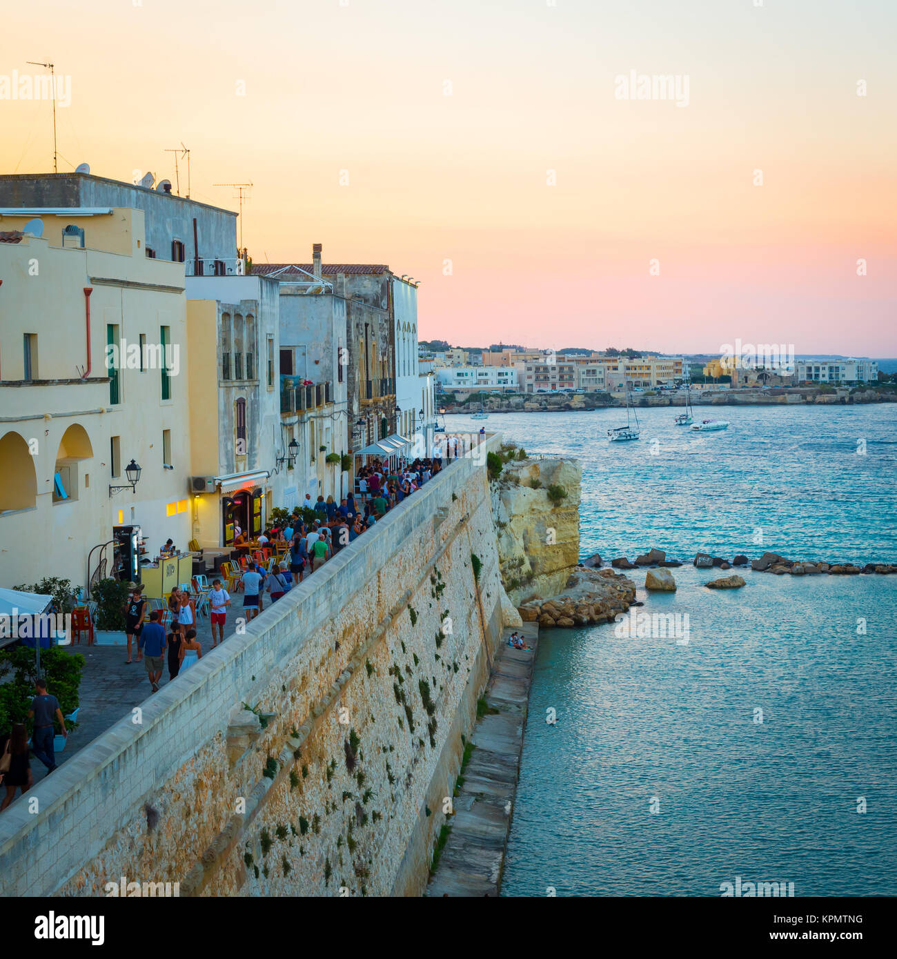 At peak of turistic season, the turist crowd is walking at sunset on ...