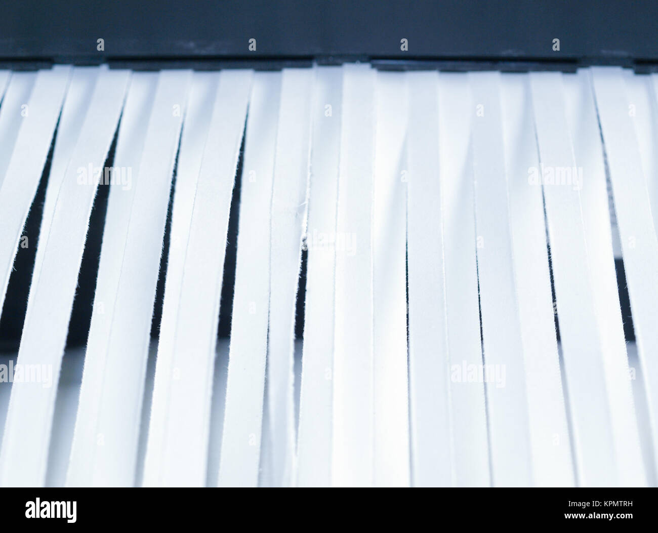 Paper documents cut into strips with a paper shredder Stock Photo - Alamy
