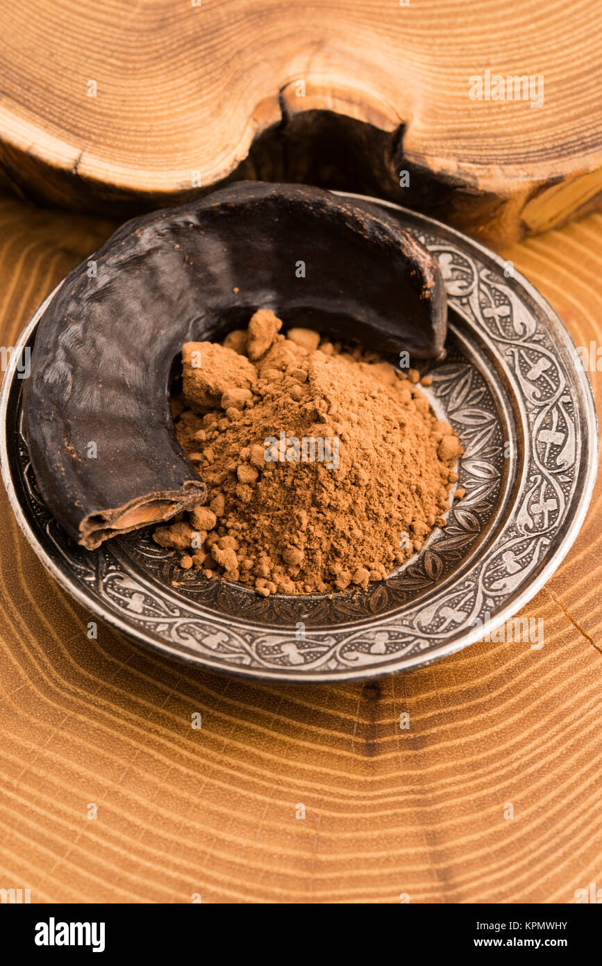 carob pods and carob powder Stock Photo - Alamy
