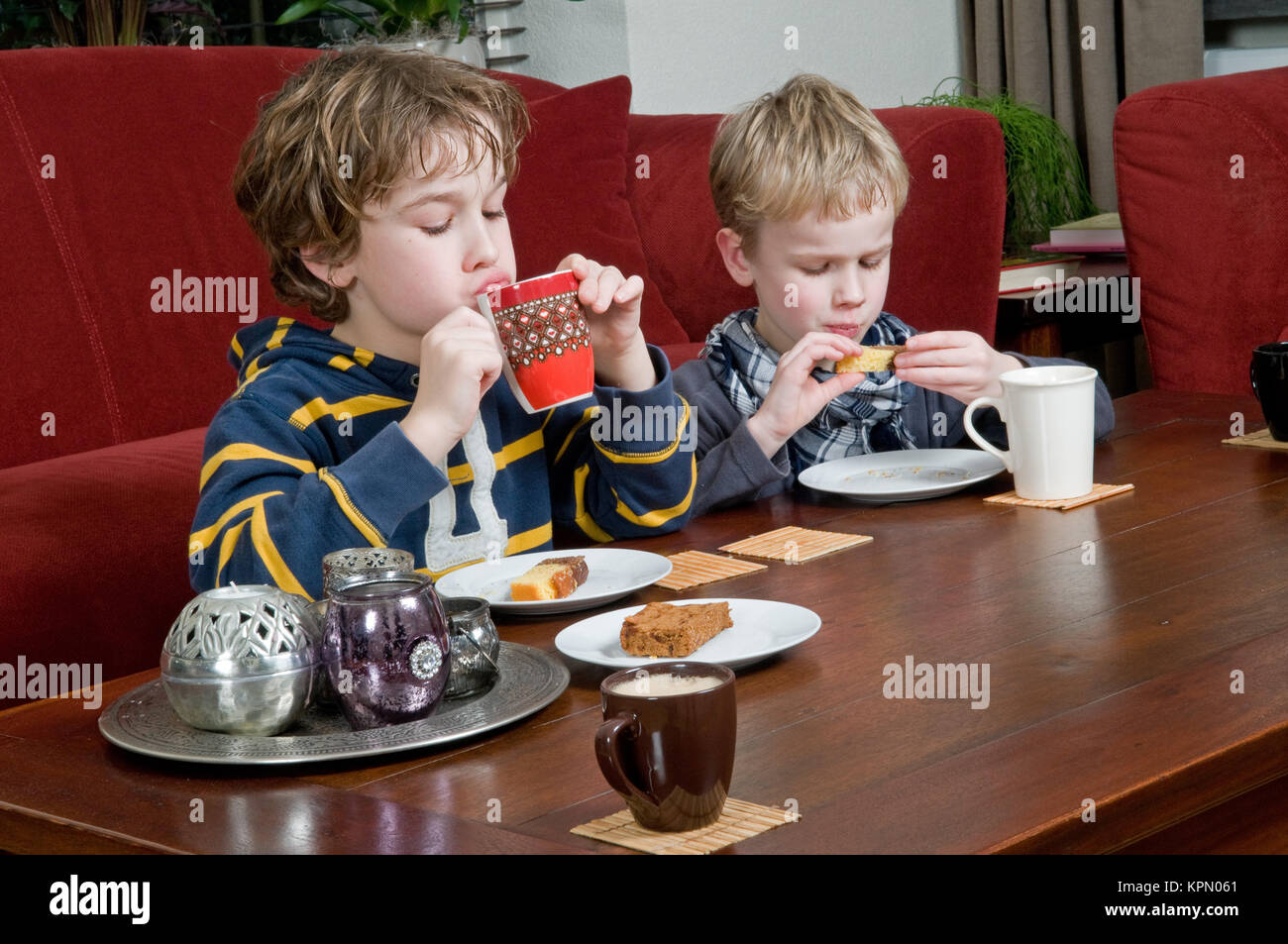 Two brothers in a livingroom Stock Photo - Alamy