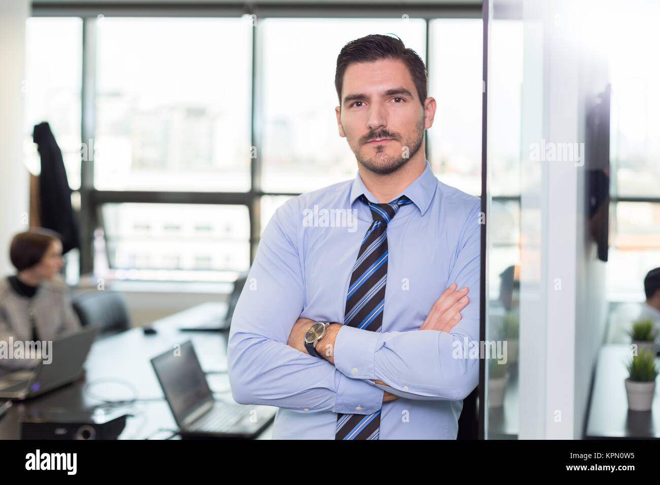 Team leader with coworkers working in office Stock Photo - Alamy