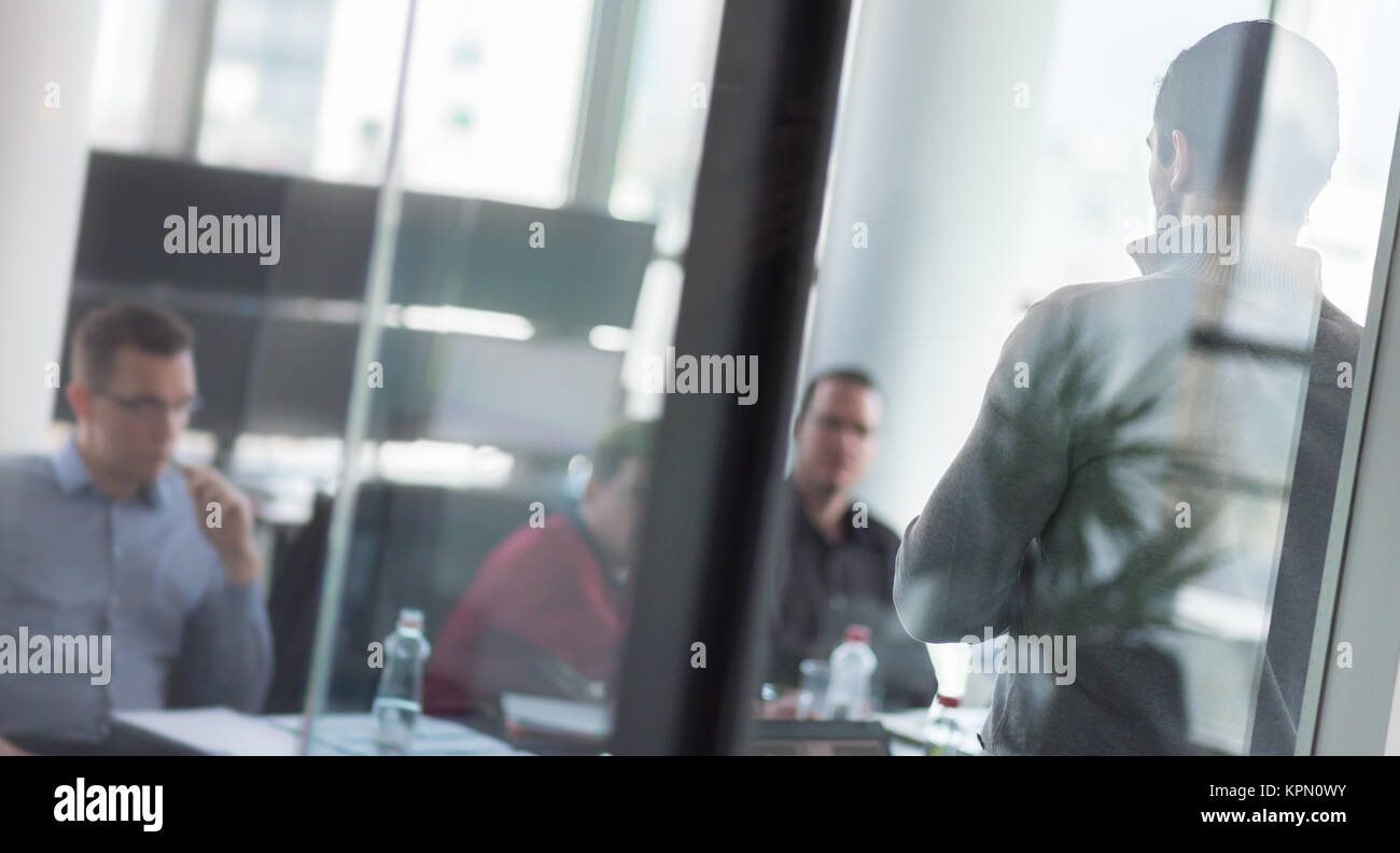 Business team leader delivering presentation in office Stock Photo - Alamy