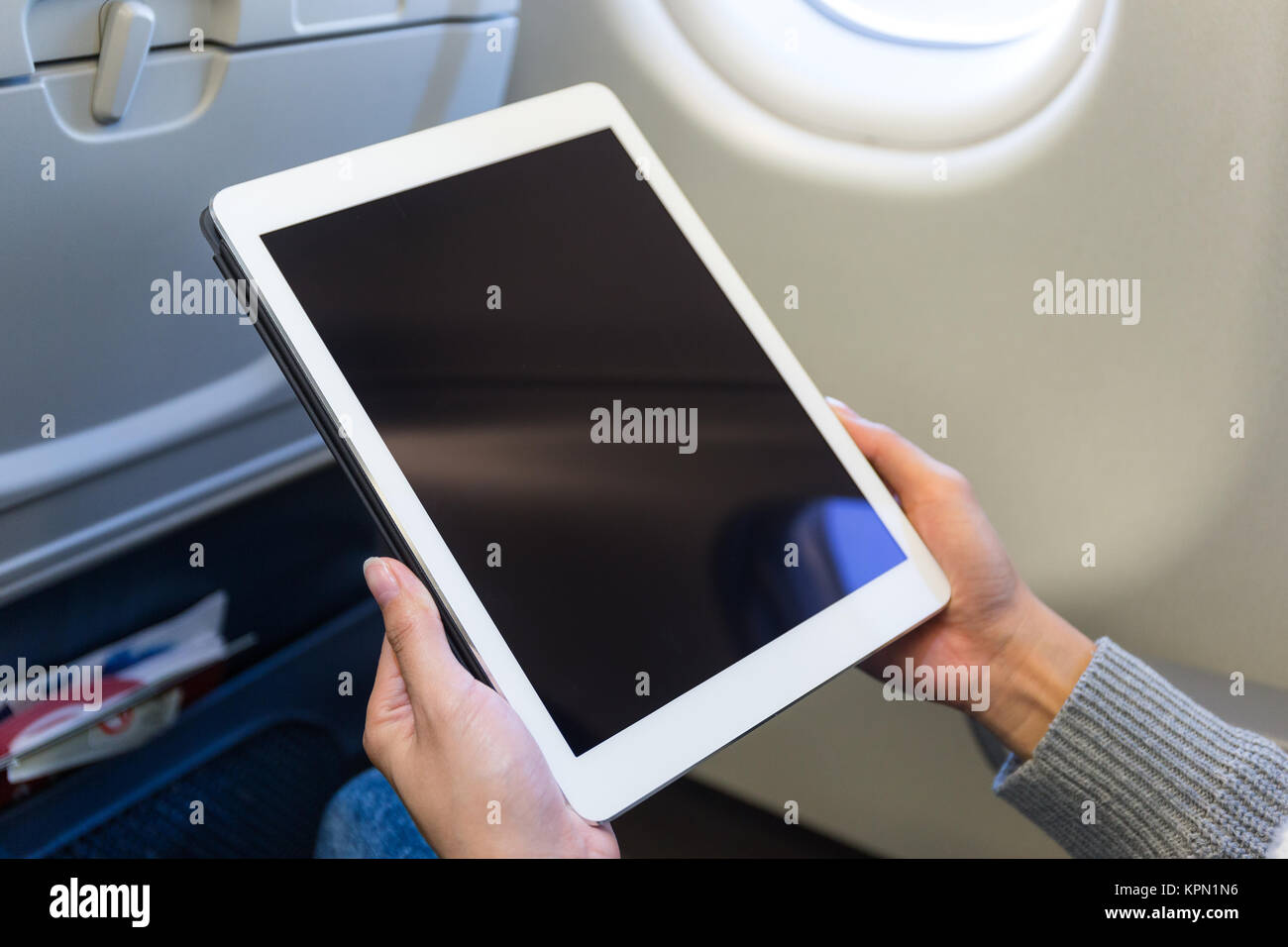 Woman use of tablet computer inside airplane Stock Photo - Alamy
